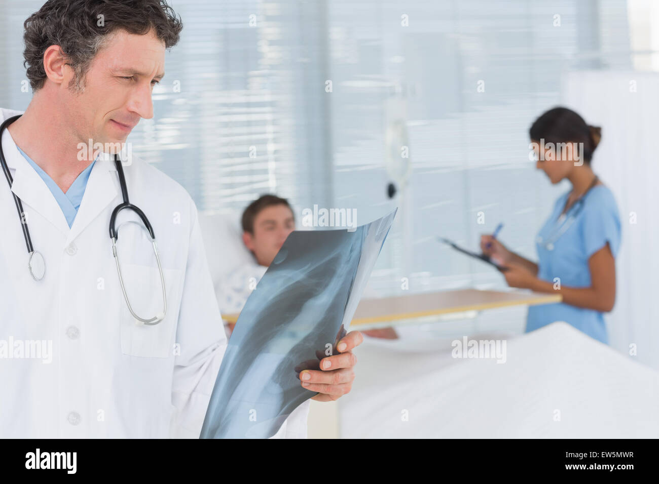 Doctor examining patients x ray hi-res stock photography and images - Alamy