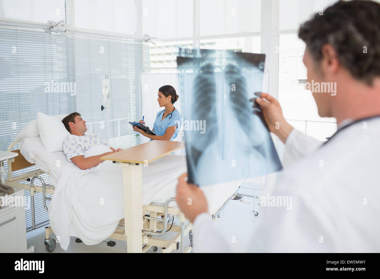 Doctor checking patients xray Stock Photo - Alamy