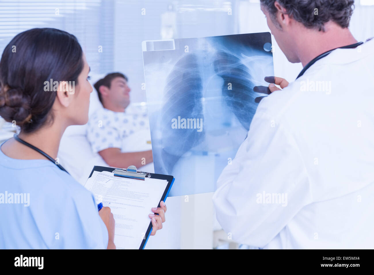 Doctors checking patients xray Stock Photo - Alamy