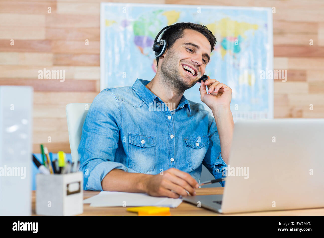 Handsome travel agent speaking with customer Stock Photo - Alamy