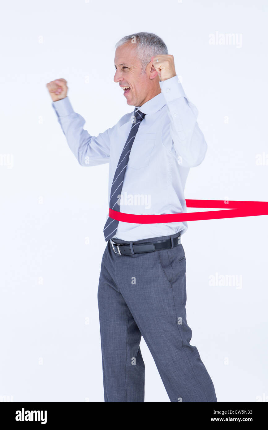 Happy businessman crossing red line Stock Photo - Alamy