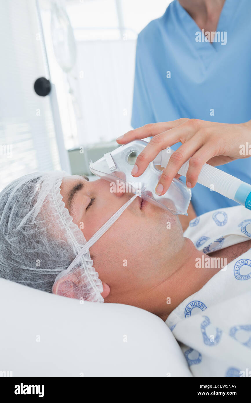 Doctor holding patients oxygen mask Stock Photo - Alamy