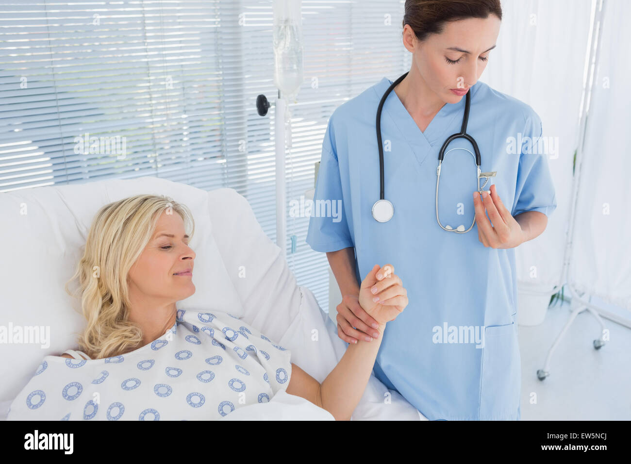 Concentrated doctor checking patients hi-res stock photography and ...