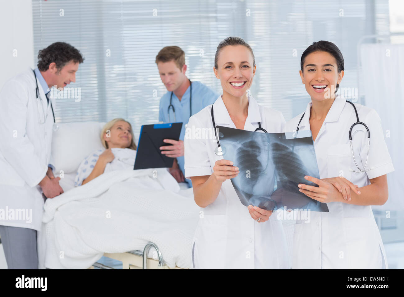Smiling doctors discussing about patients file Stock Photo - Alamy