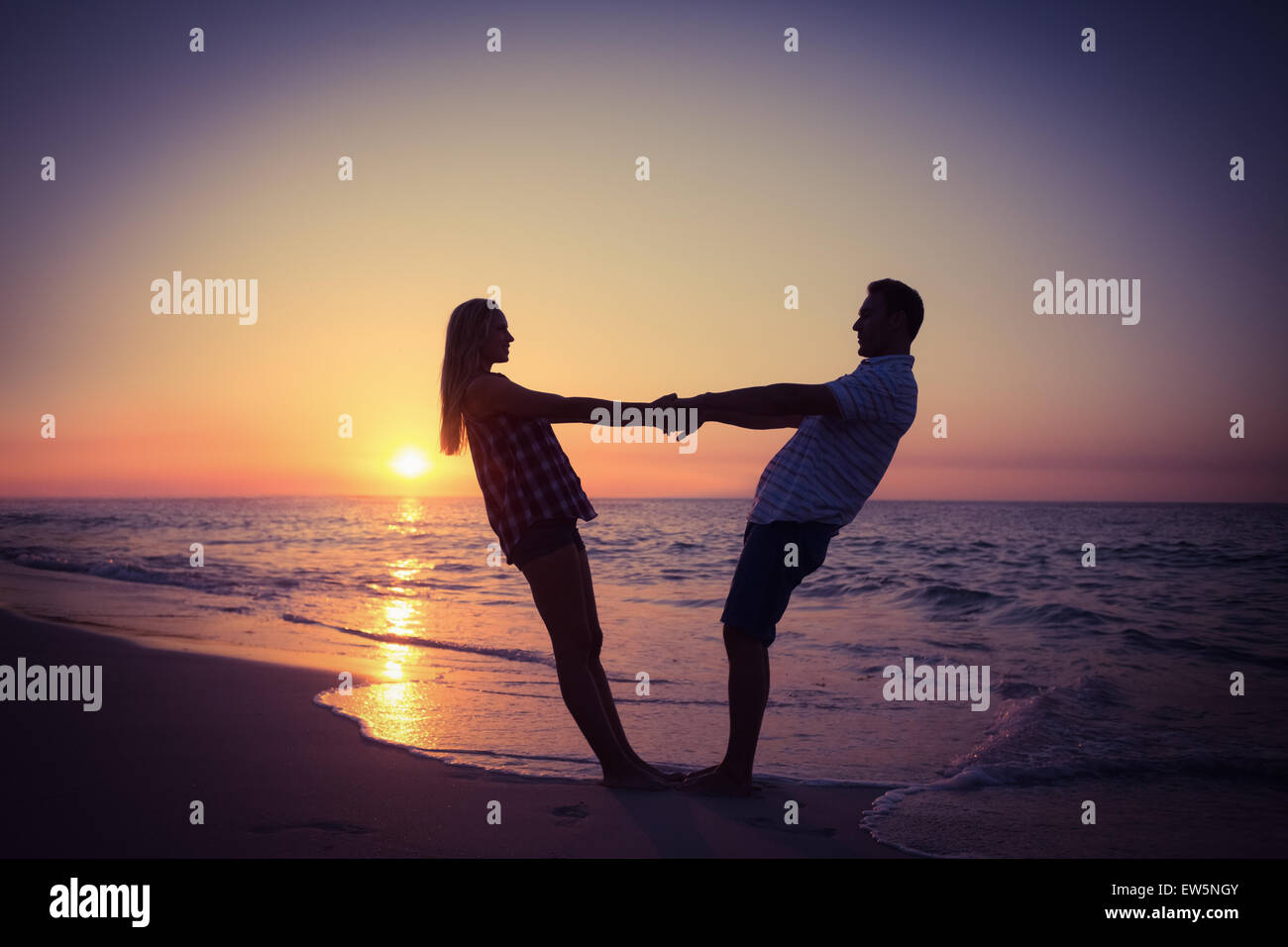 Romantic couple at sunset Stock Photo - Alamy