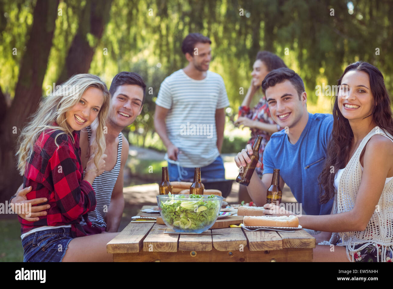 Happy friends in the park having lunch Stock Photo - Alamy
