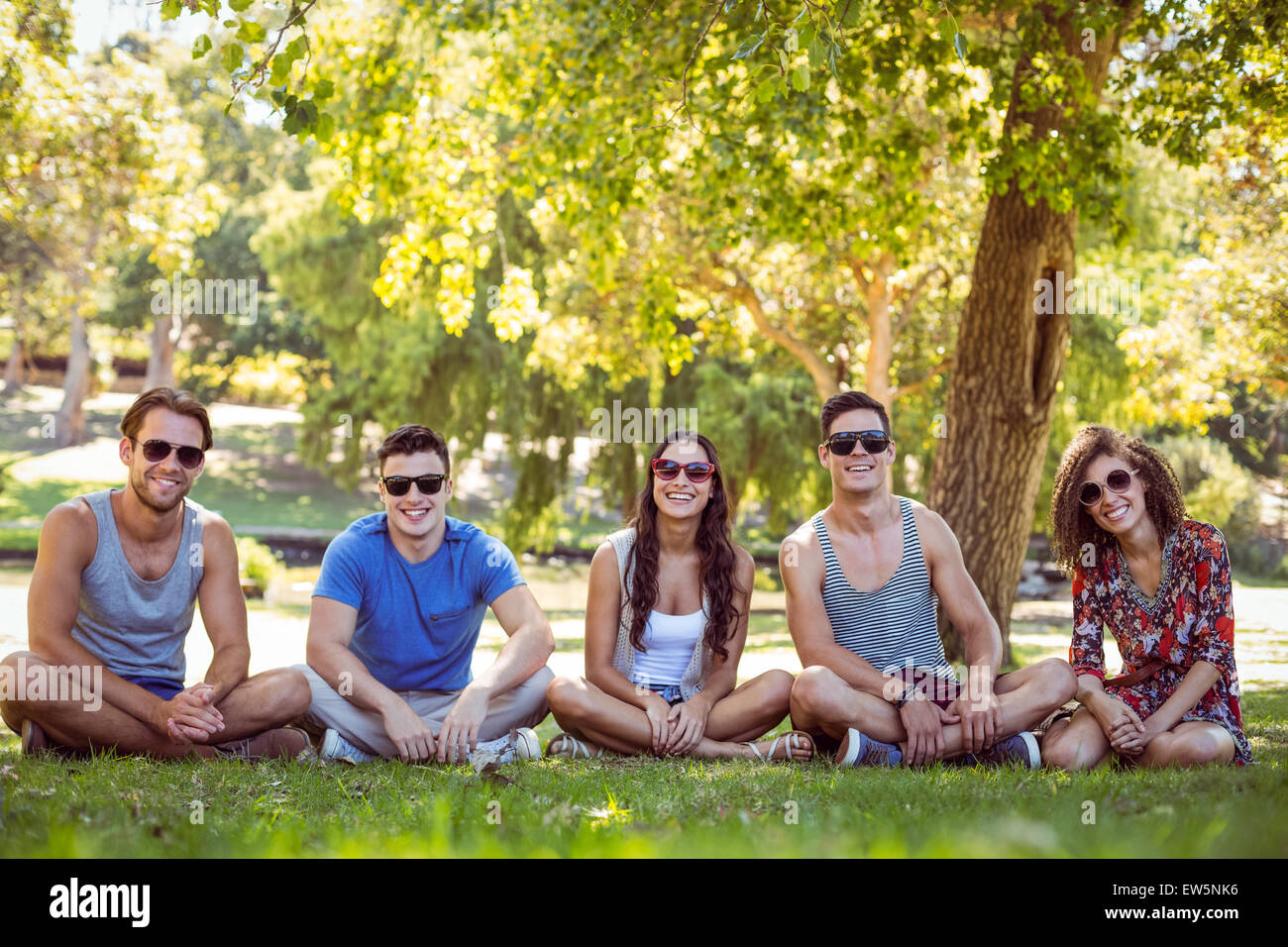 Friends smiling to the camera Stock Photo - Alamy