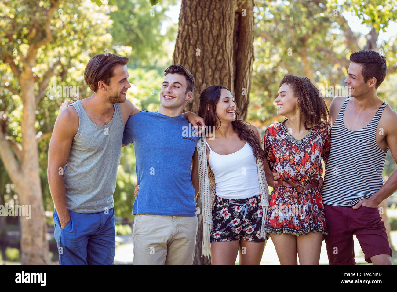 Friends talking in the park Stock Photo - Alamy