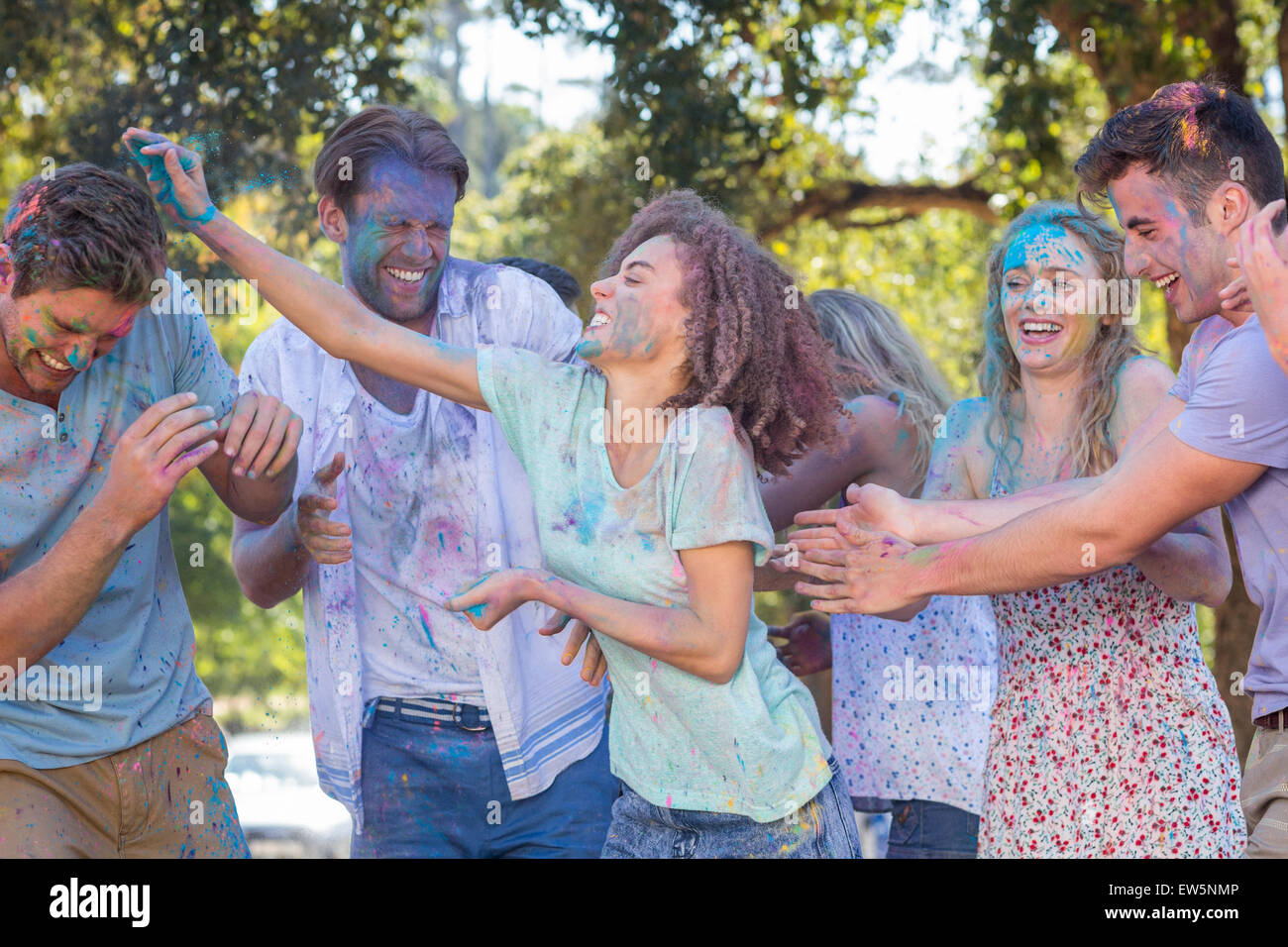 Friends throwing powder paint Stock Photo - Alamy