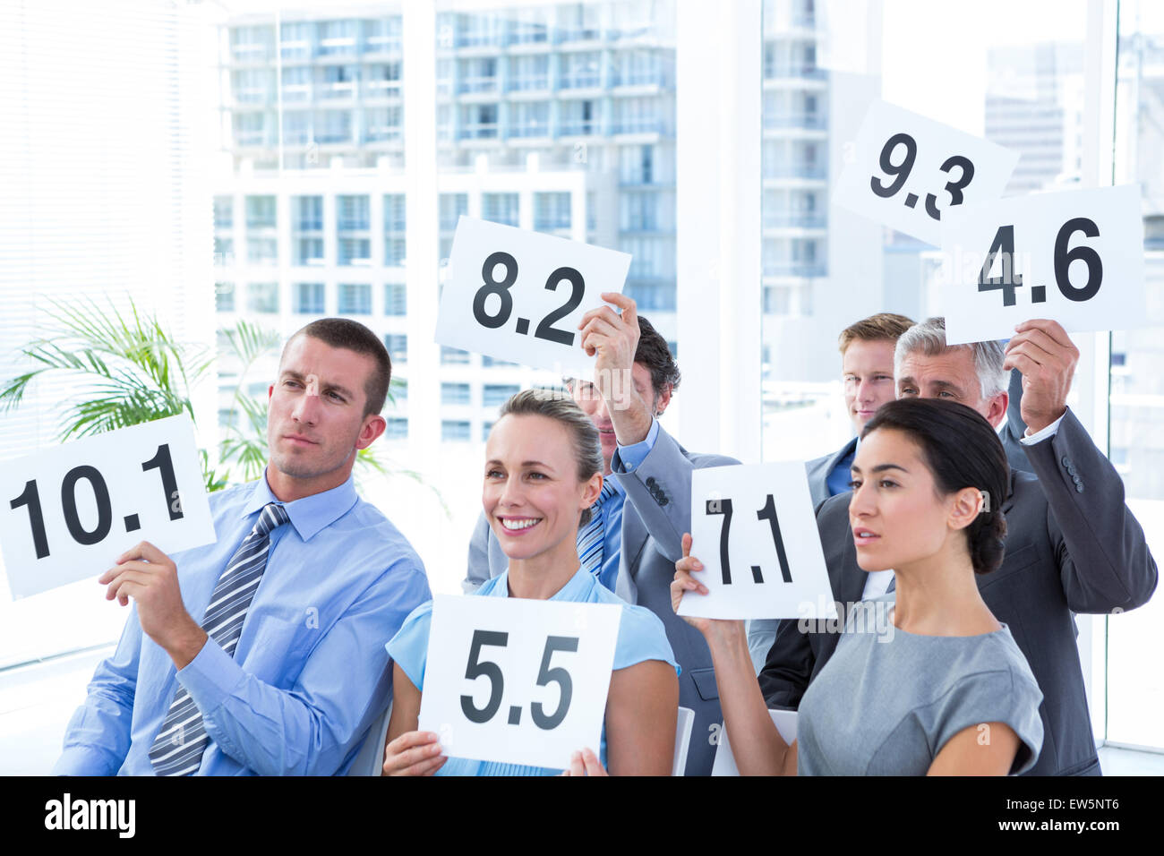 Business people holding grades Stock Photo - Alamy