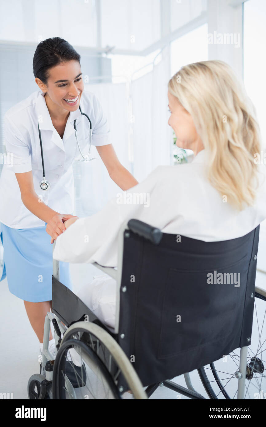 Happy doctor smiling at her patient in wheelchair Stock Photo - Alamy