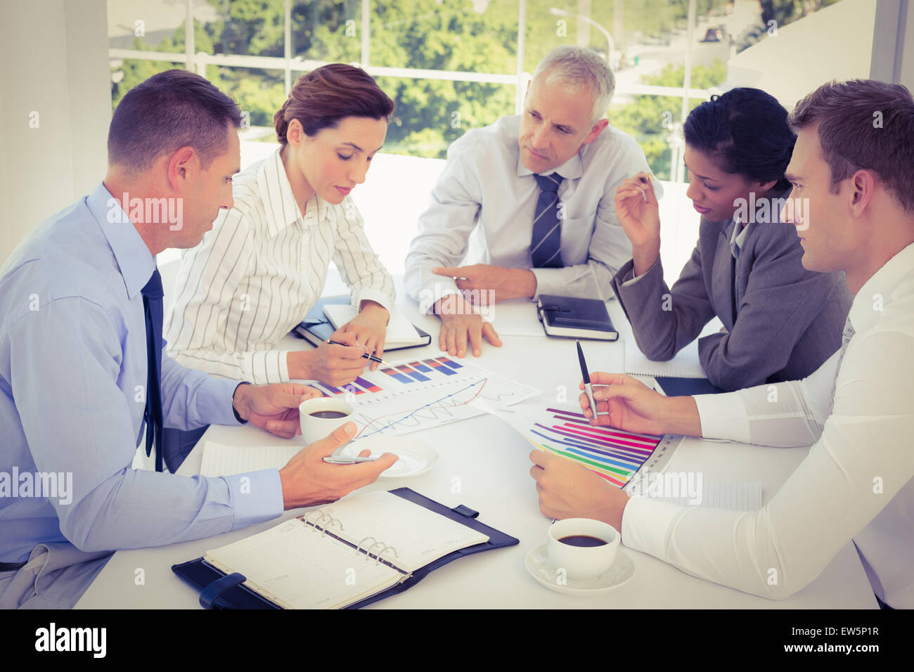 Business team analyzing bar chart graphs Stock Photo - Alamy