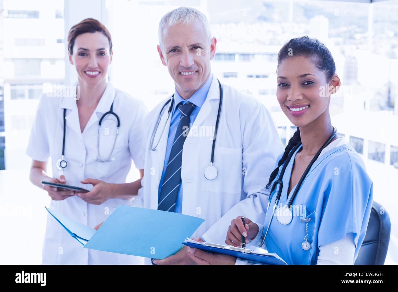 Doctors working together on patients file Stock Photo - Alamy