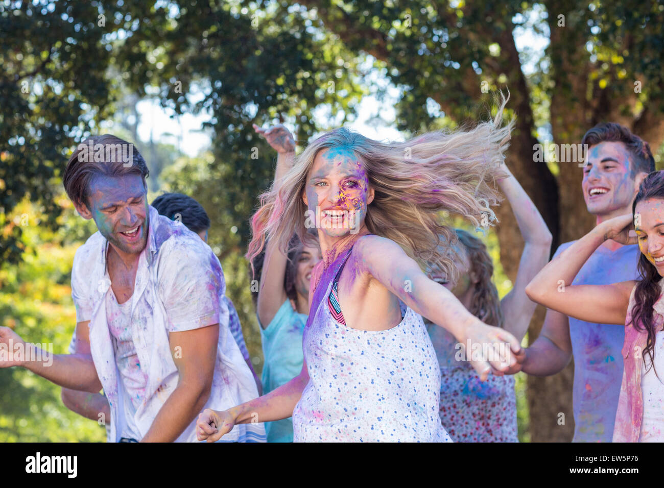Happy friends covered in powder paint Stock Photo - Alamy