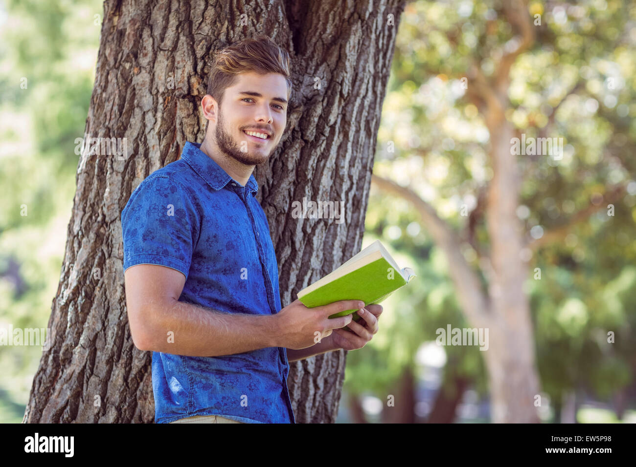 Young man reading a book Stock Photo - Alamy