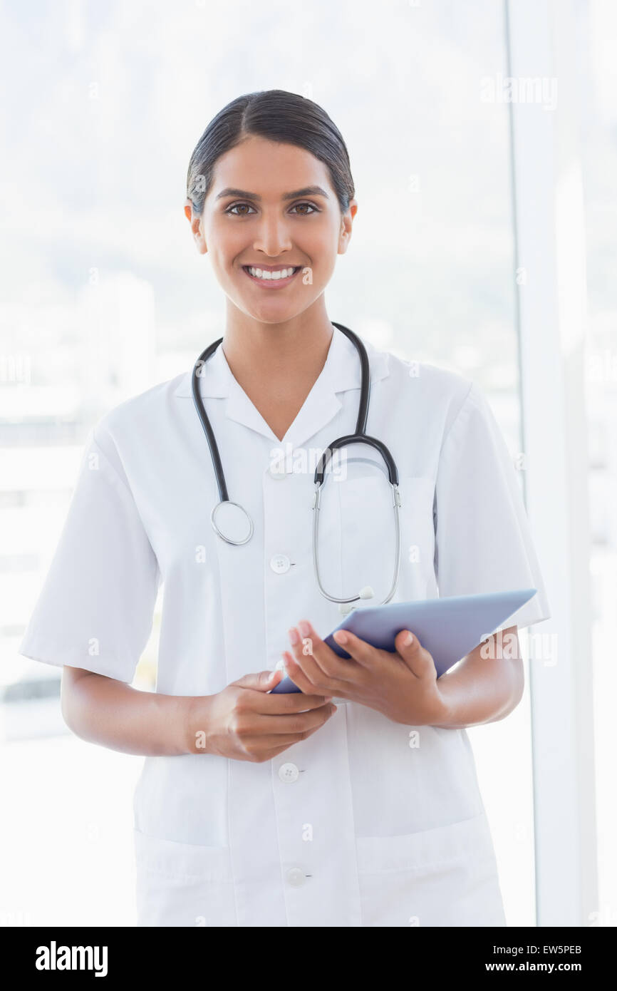 Happy doctor holding clipboard Stock Photo - Alamy