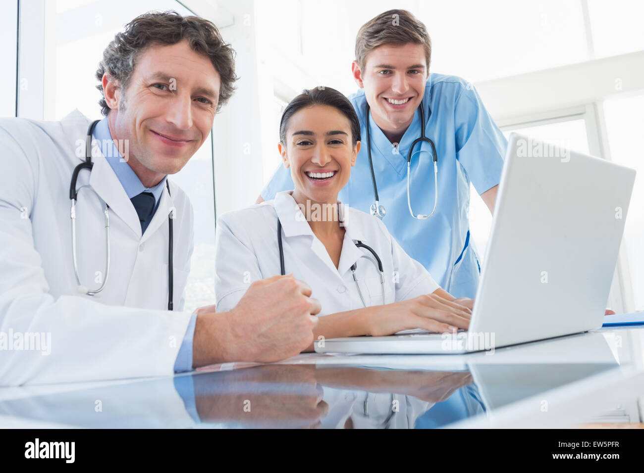Team of doctors smiling at camera Stock Photo - Alamy