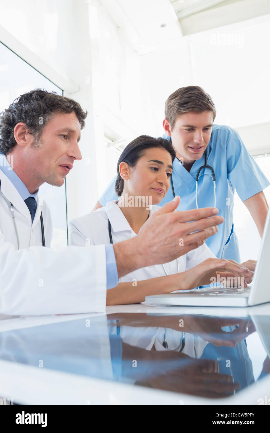 Team of doctors working on laptop computer Stock Photo - Alamy