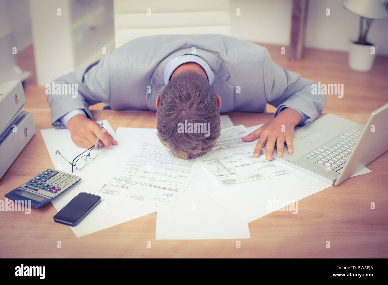 Business tired and working on laptop Stock Photo - Alamy