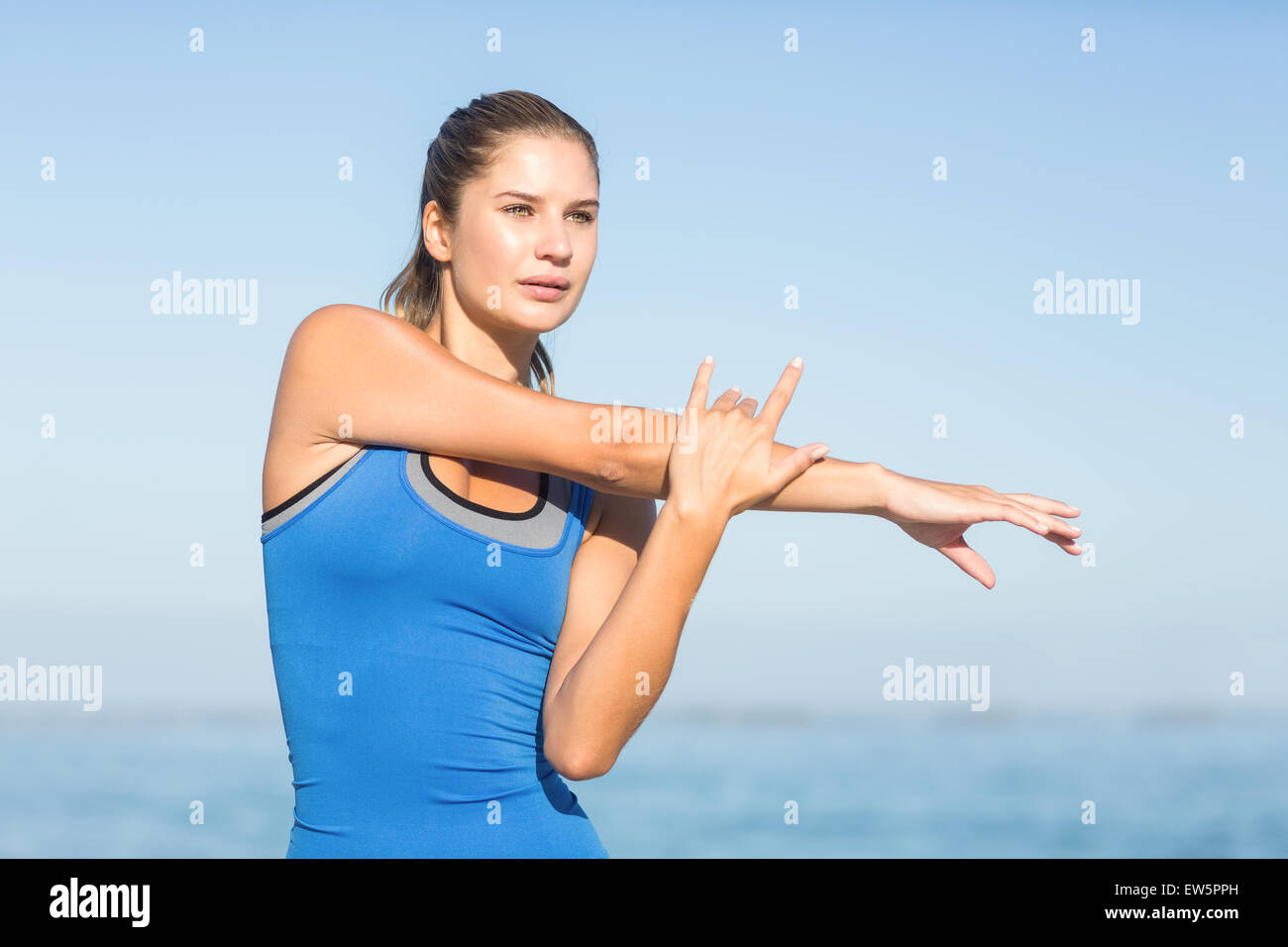 Beautiful fit woman stretching arm hi-res stock photography and images ...