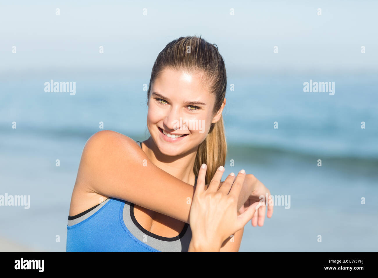 Beautiful fit woman stretching her arm Stock Photo - Alamy