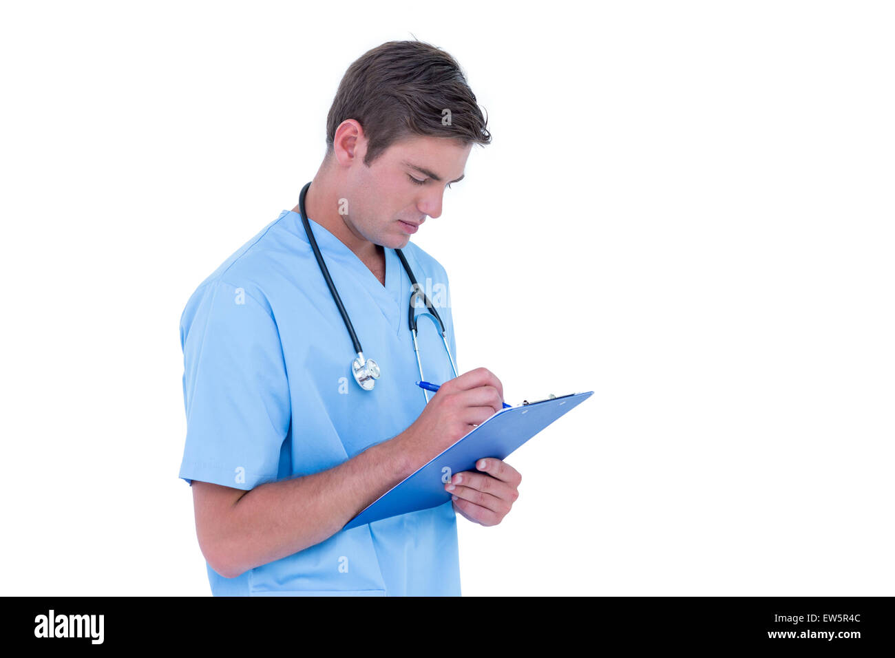Young nurse in blue tunic writing notes Stock Photo - Alamy