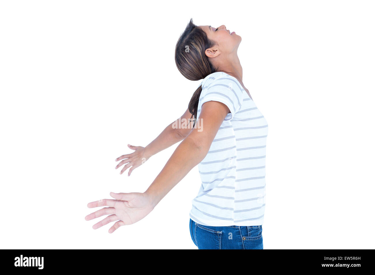 Side view of pretty brunette with arms outstretched Stock Photo - Alamy