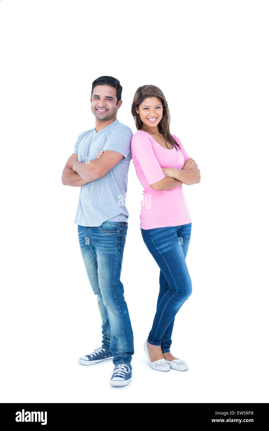 Happy friends with arms crossed back to back Stock Photo - Alamy