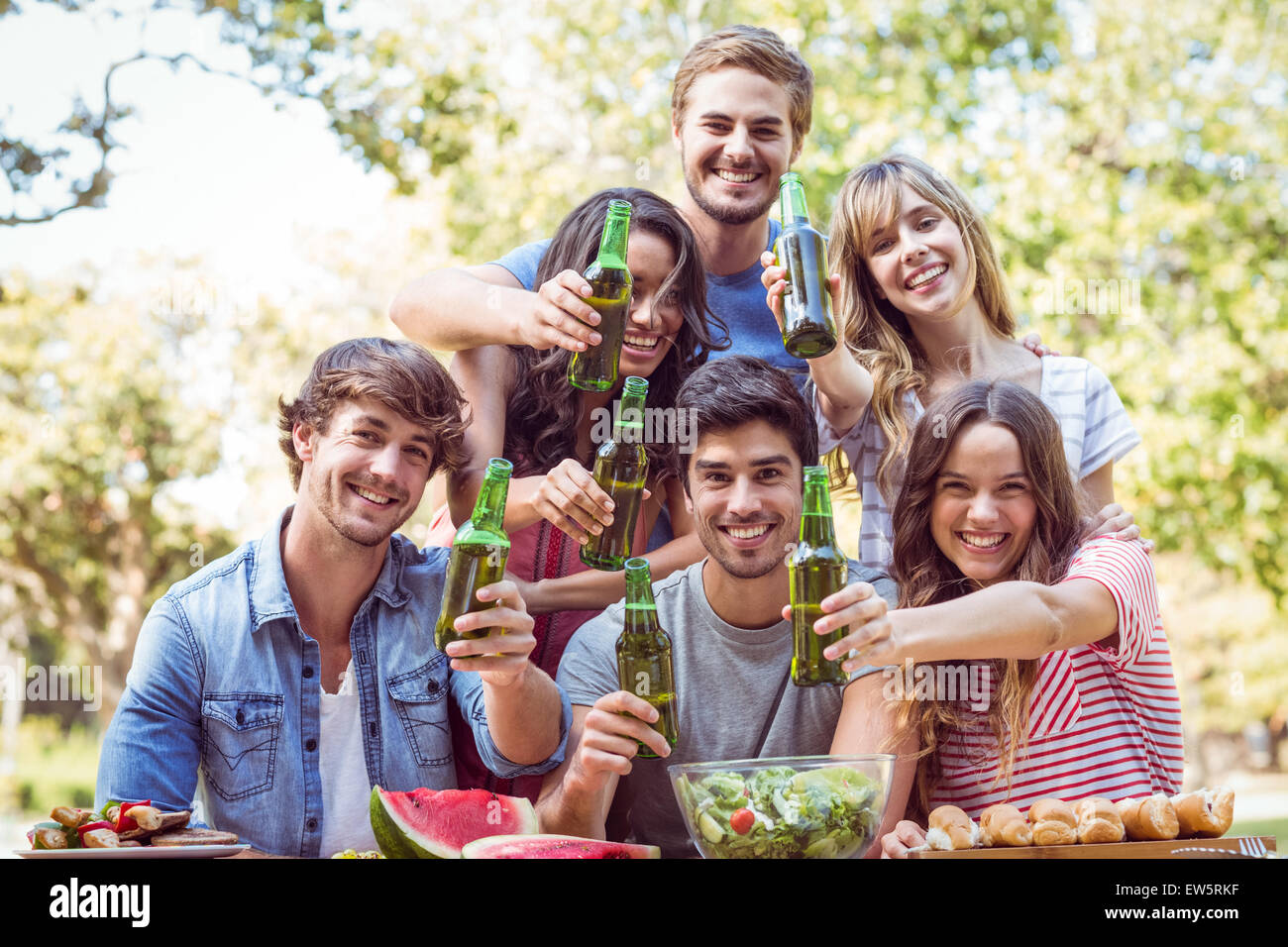 Happy friends in the park having lunch Stock Photo - Alamy