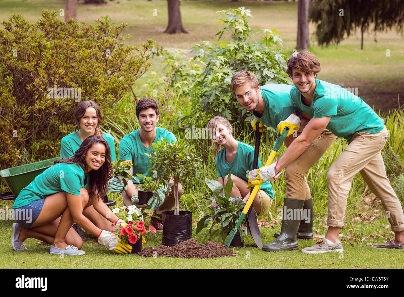 Happy friends gardening for the community Stock Photo - Alamy