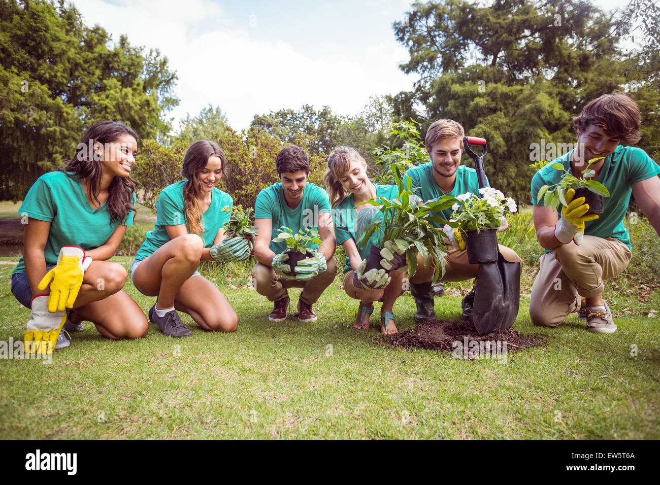 Happy friends gardening for the community Stock Photo - Alamy