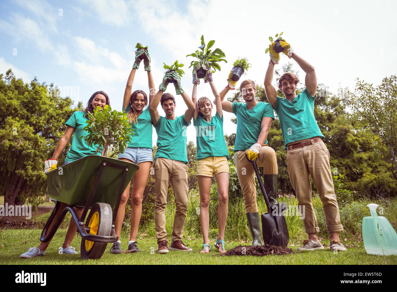 Happy friends gardening for the community Stock Photo - Alamy