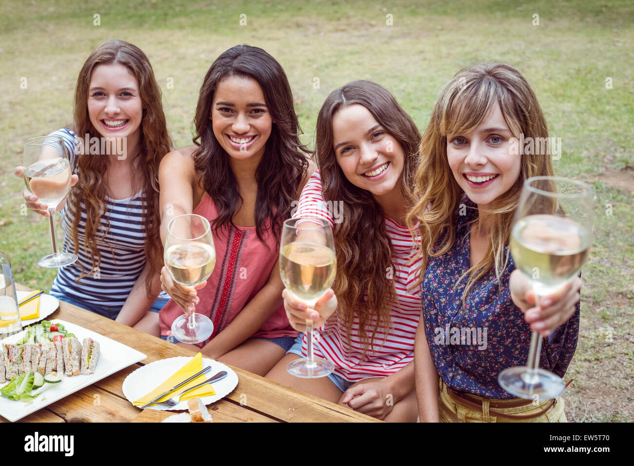 happy friends in a park having a picnic Stock Photo - Alamy