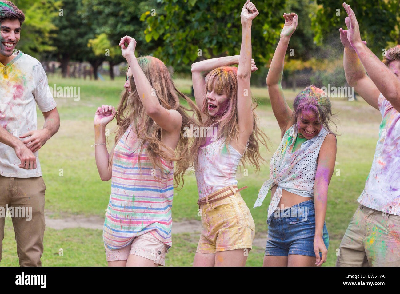Happy friends covered in powder paint Stock Photo - Alamy