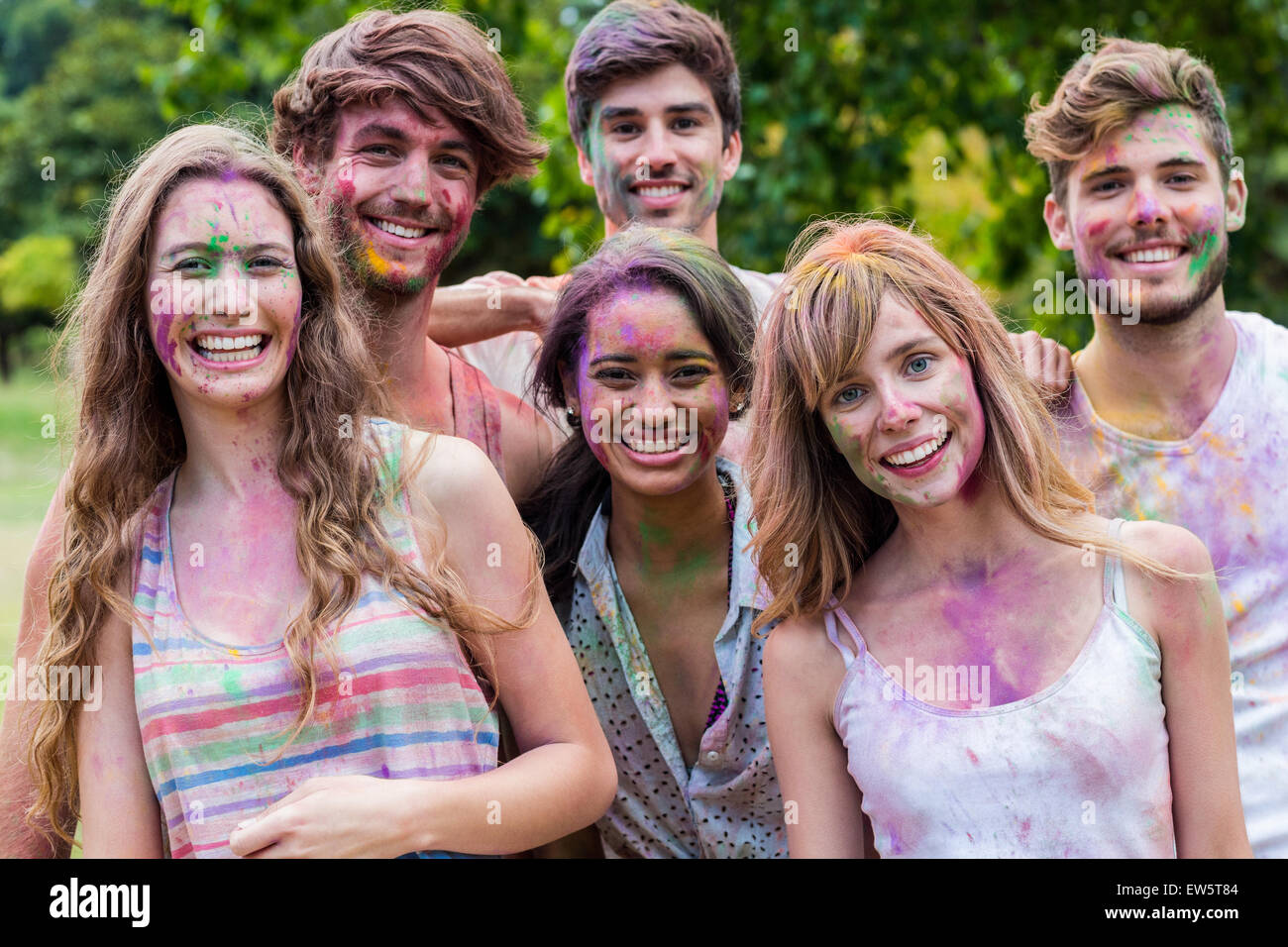 Happy friends covered in powder paint Stock Photo - Alamy
