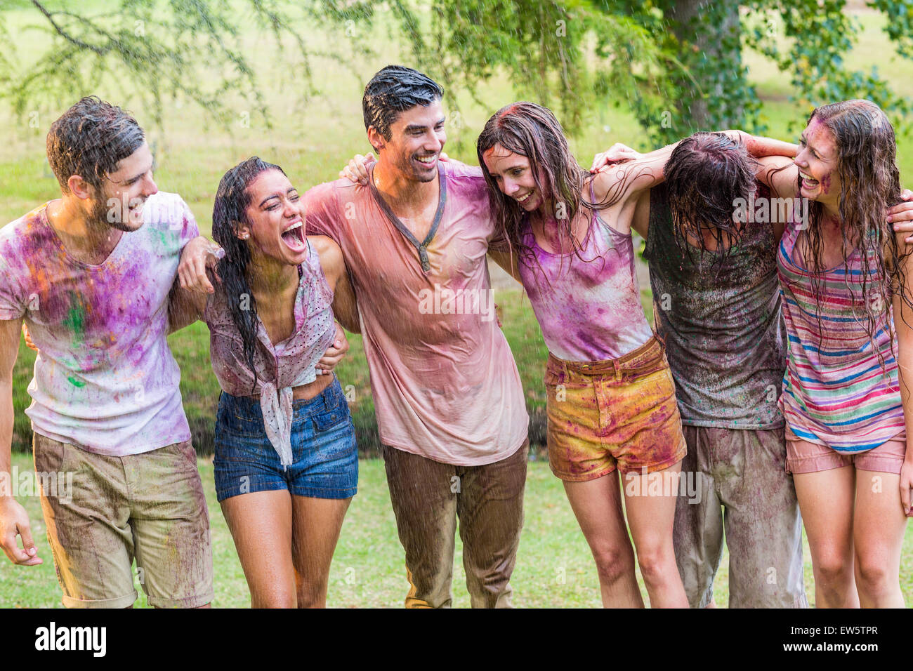 Happy friends covered in powder paint Stock Photo - Alamy