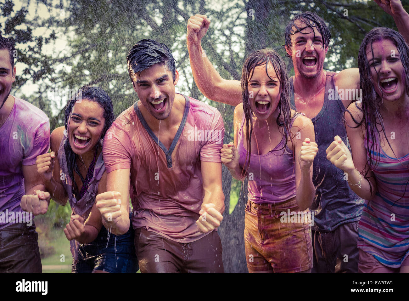 Happy friends covered in powder paint Stock Photo - Alamy