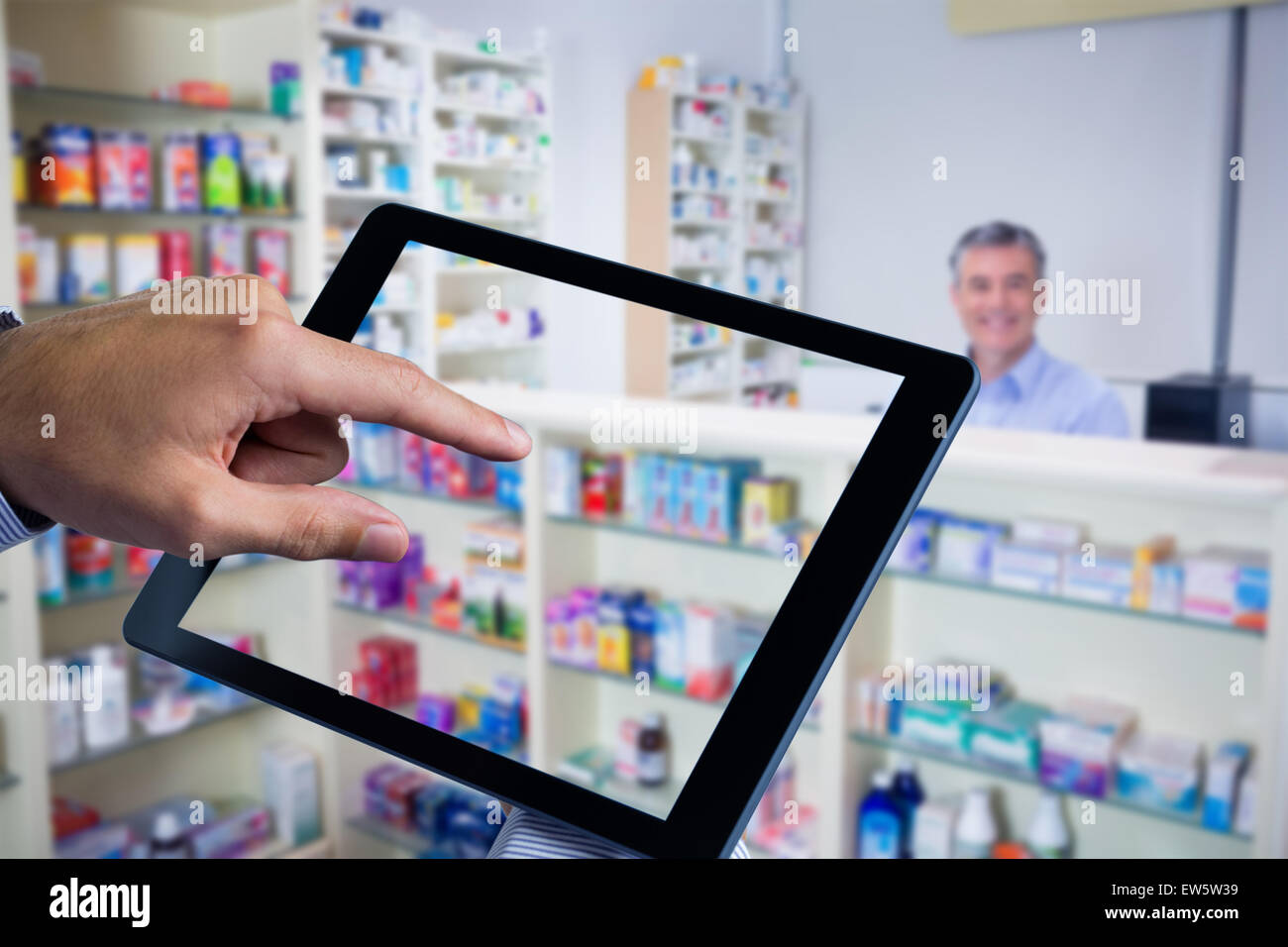 Composite image of man using tablet pc Stock Photo - Alamy