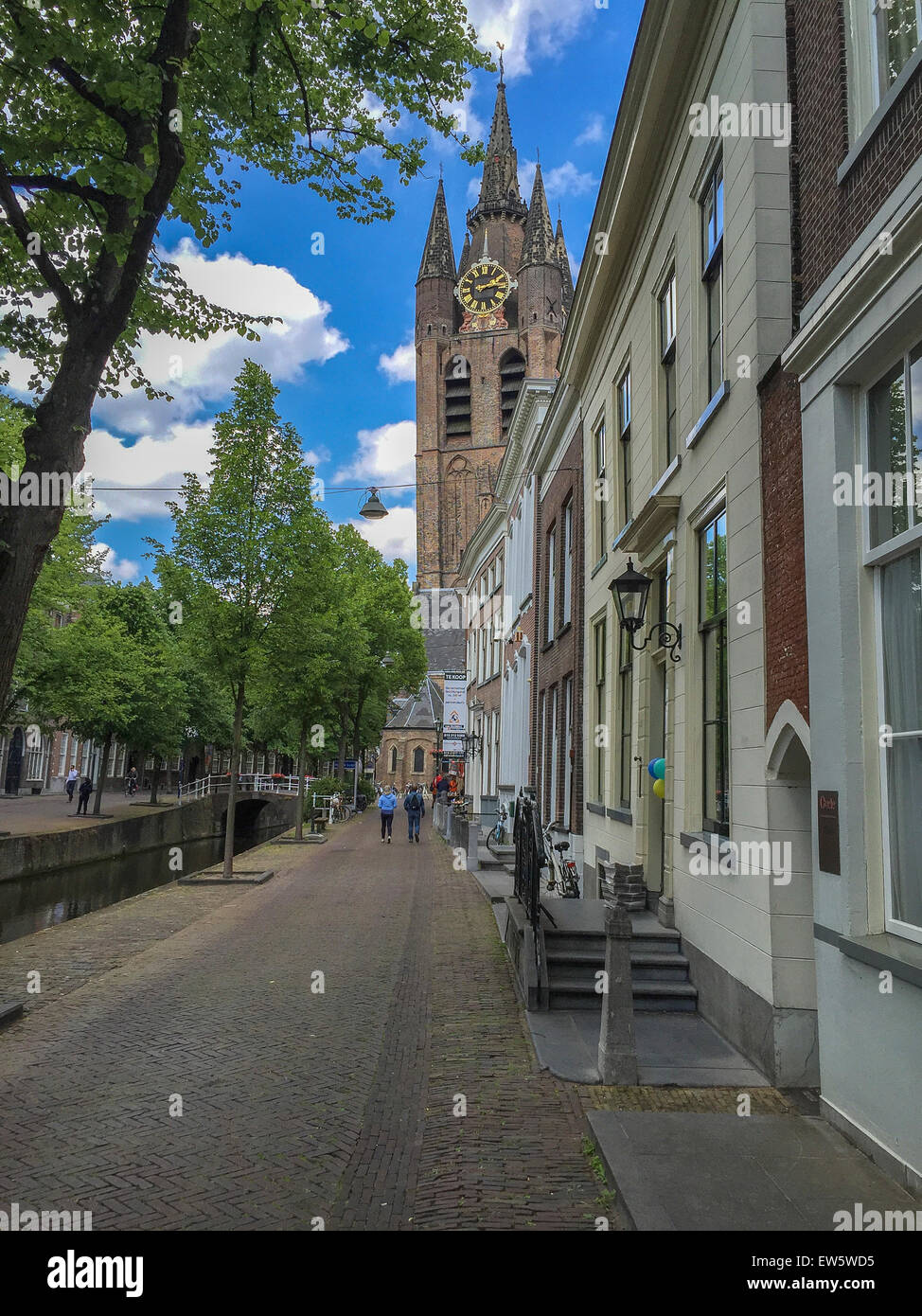 Street and The Oude Kerk (Old Church), in the old city center of Delft ...