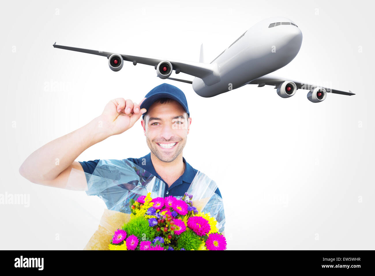 Composite image of happy delivery man holding bouquet Stock Photo - Alamy