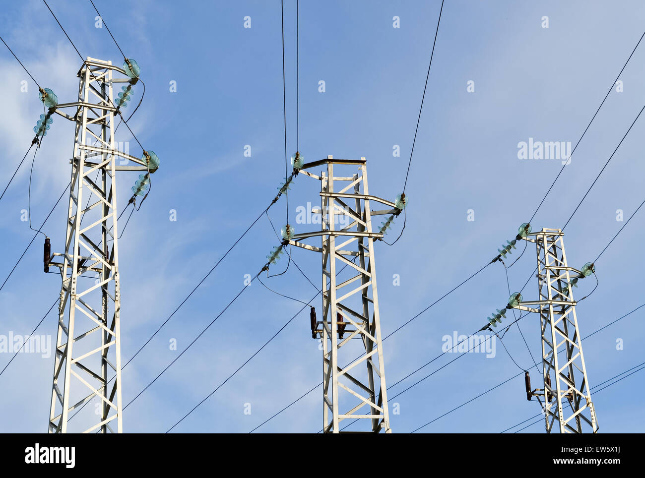 Three steel high-voltage transmission lines and clear blue sky Stock ...