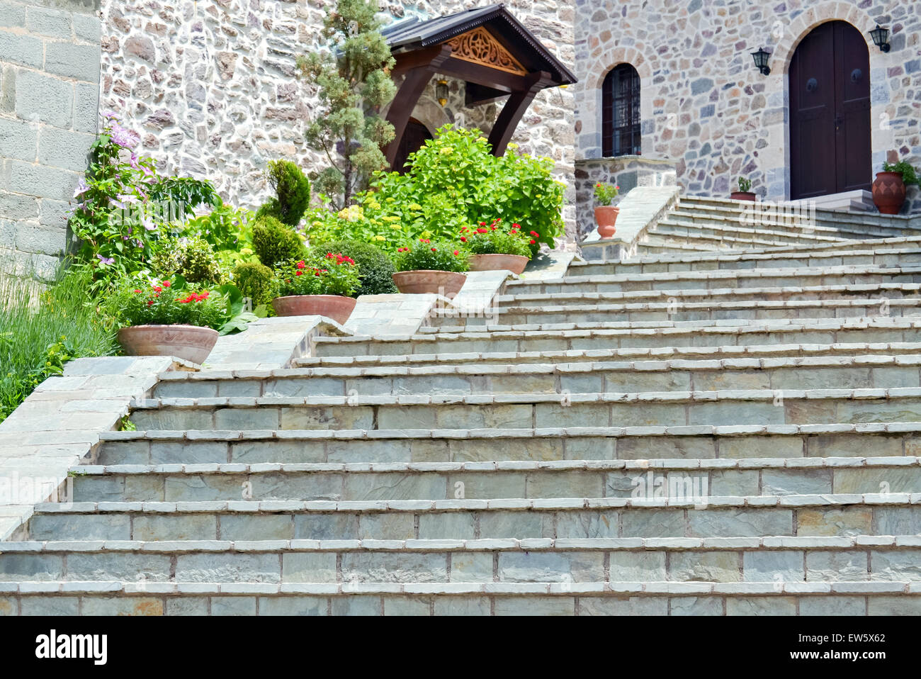 Entrance of a mediterranean monastery with old style stairs in the yard ...