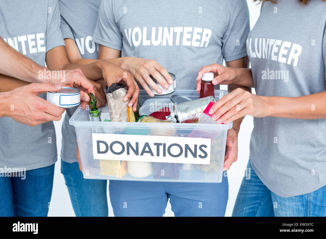 Volunteers friends separating donation stuffs Stock Photo - Alamy