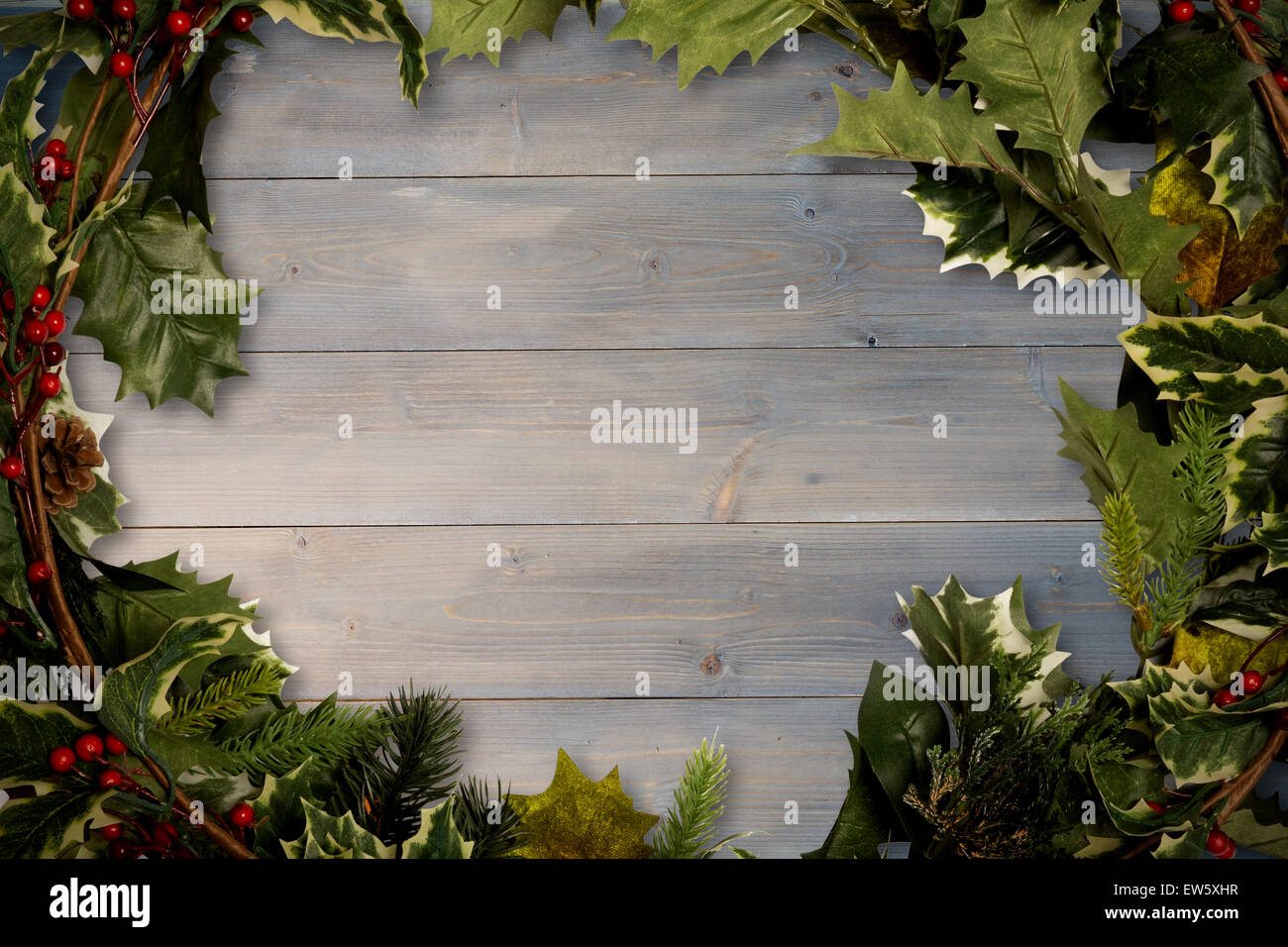 Holly twigs over wooden planks Stock Photo - Alamy