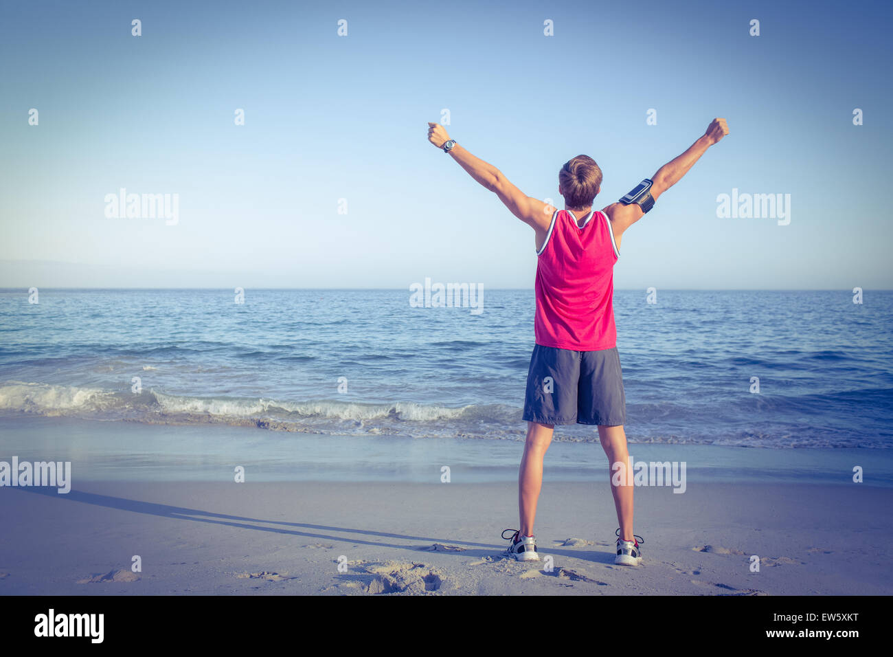 Handsome man raising arms Stock Photo - Alamy