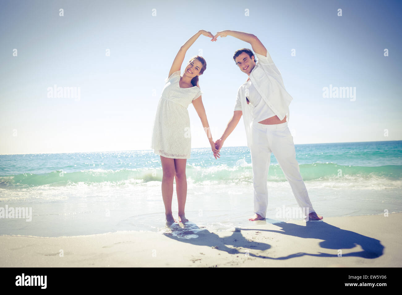 Happy couple forming heart shape with their hands Stock Photo - Alamy