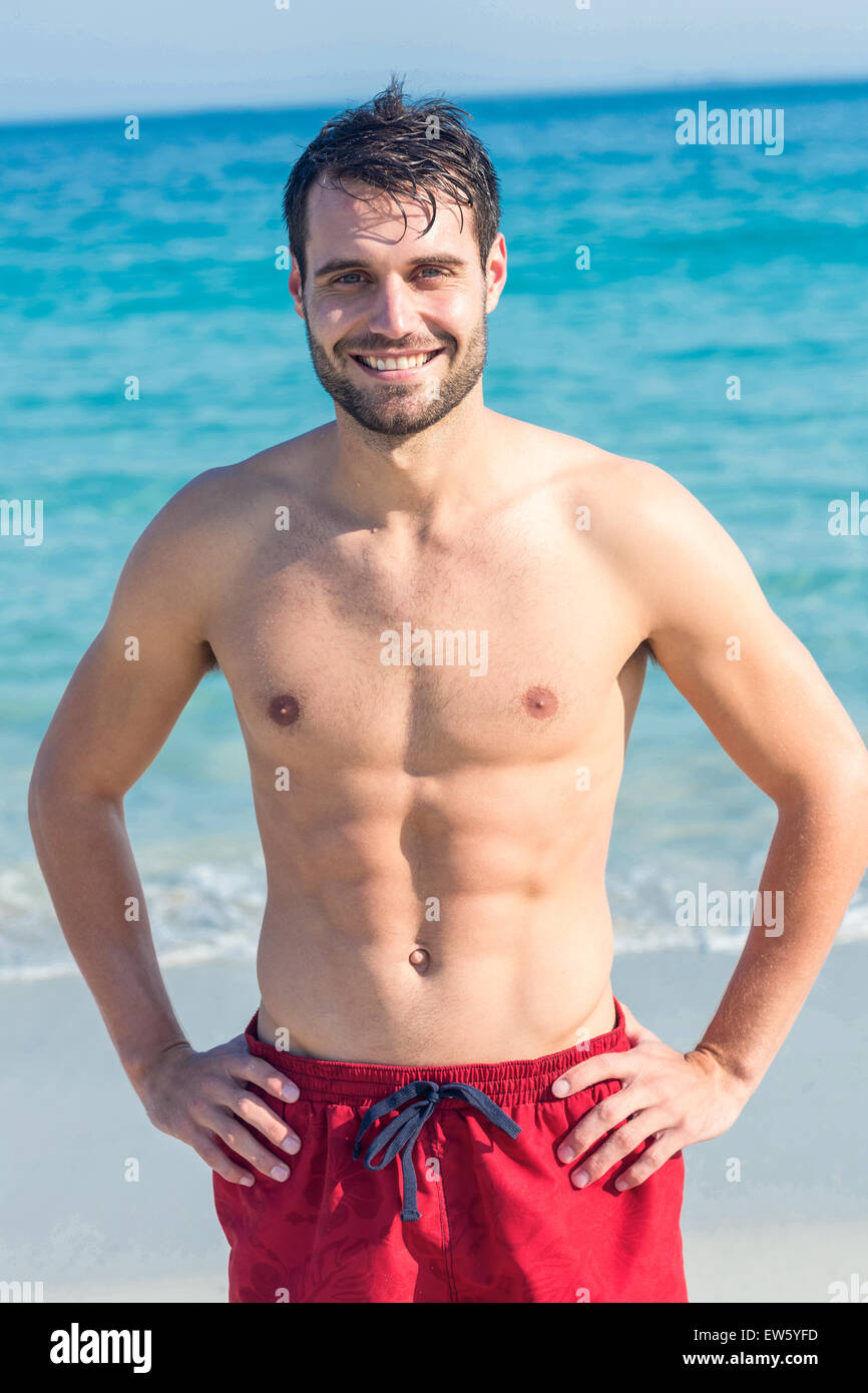 Smiling man at the beach looking at camera Stock Photo - Alamy