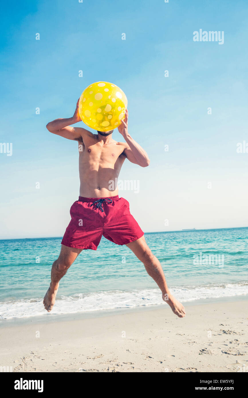 Happy man jumping on the beach Stock Photo - Alamy