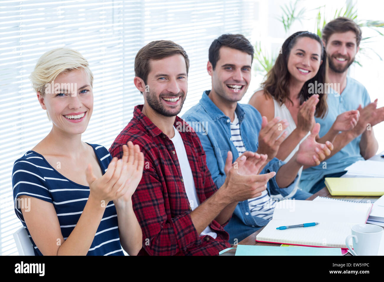 Colleagues clapping hands in meeting Stock Photo - Alamy