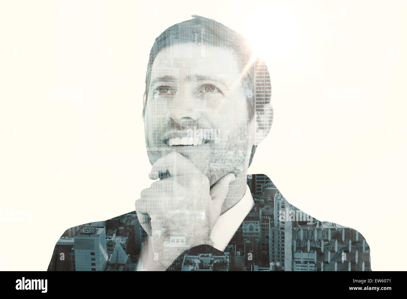 Composite image of businessman smiling and thinking Stock Photo - Alamy